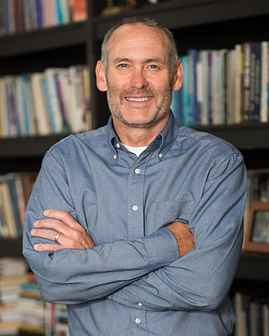 Ron Moore wearing a blue shirt and smiling | Thy Word Network